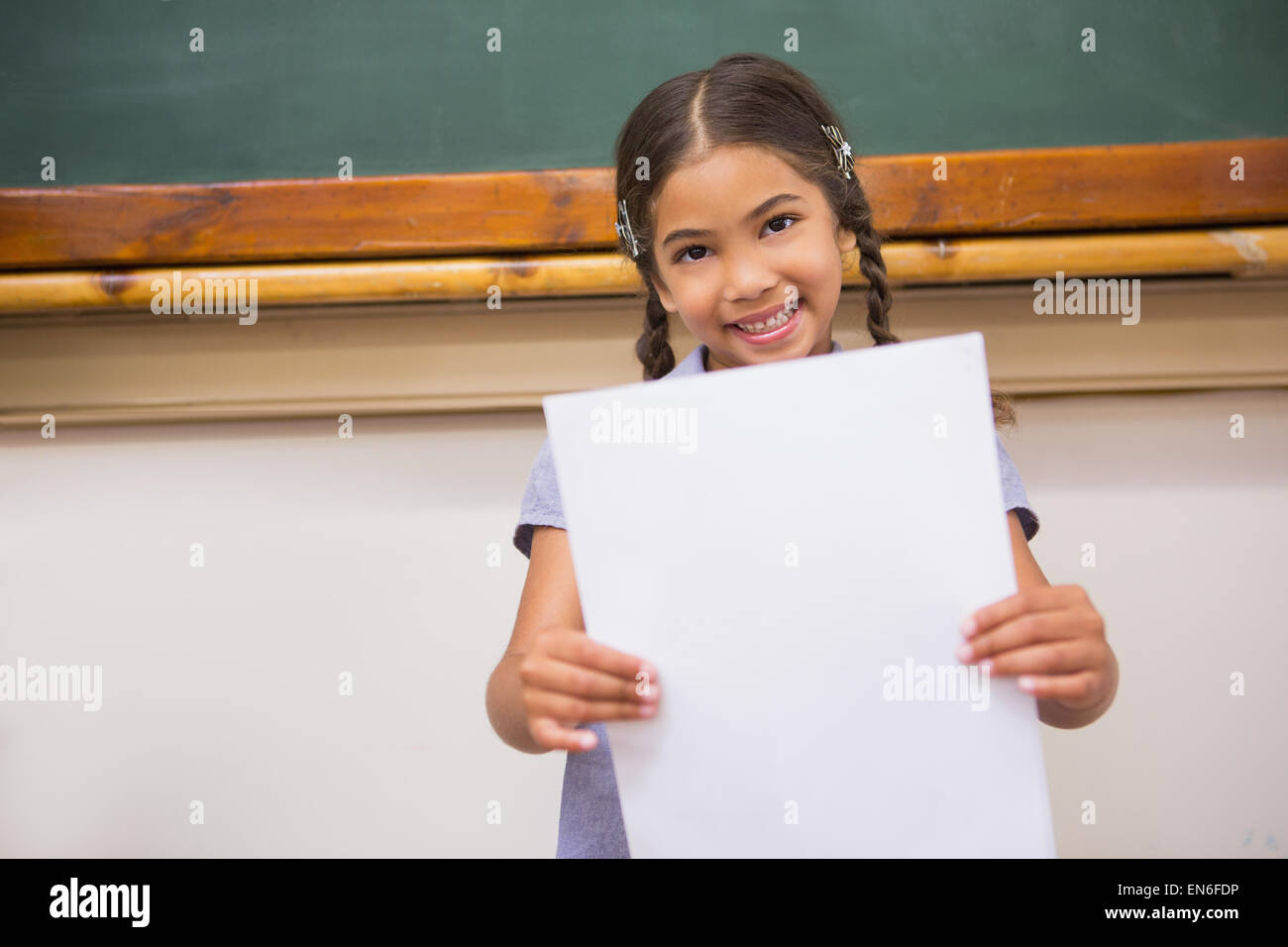 Smiling pupil showing paper Stock Photo - Alamy