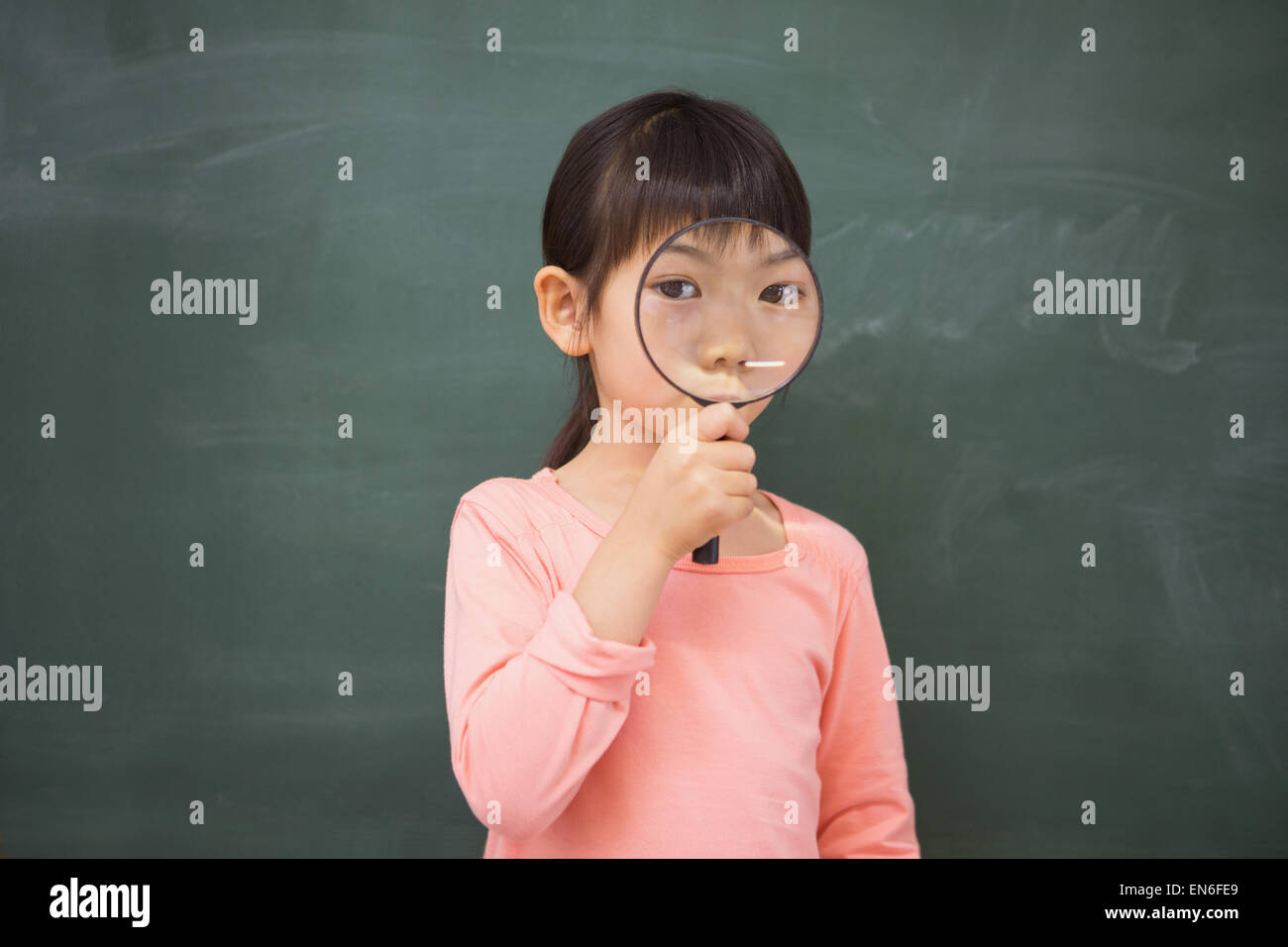 Pupil looking camera with magnifying glass Stock Photo - Alamy