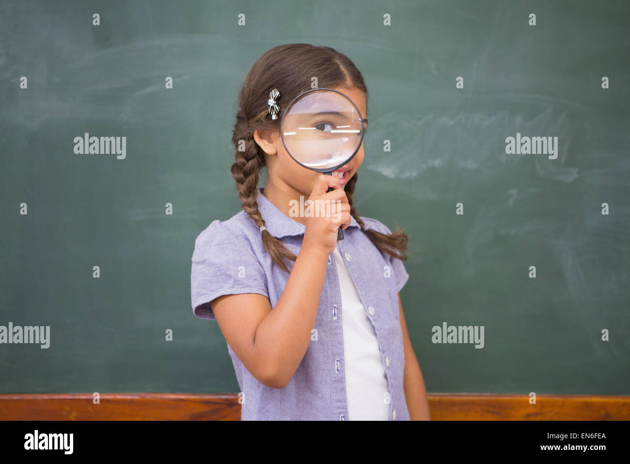 Pupil looking camera with magnifying glass Stock Photo - Alamy