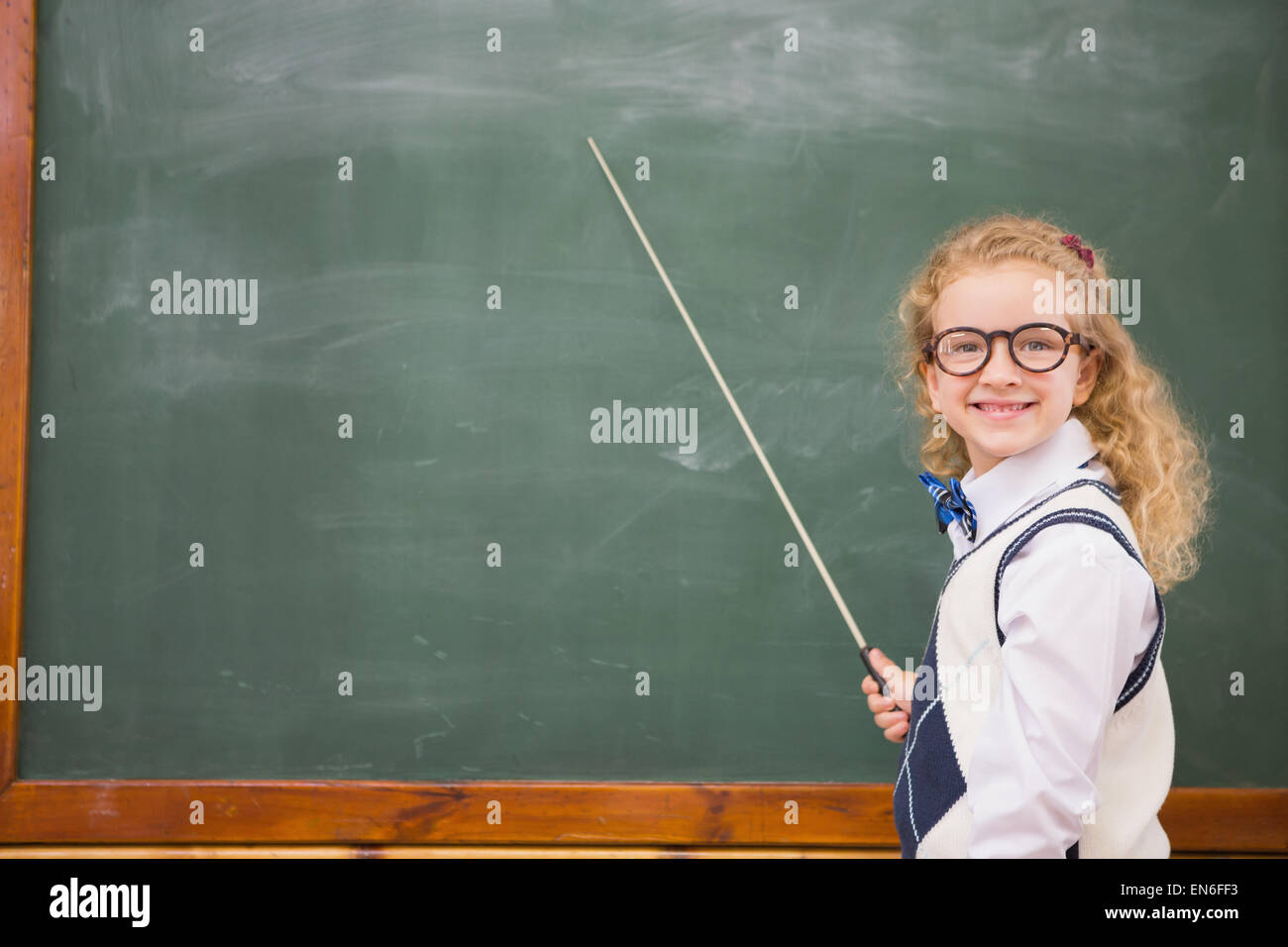 Happy pupil pointing the blackboard Stock Photo - Alamy