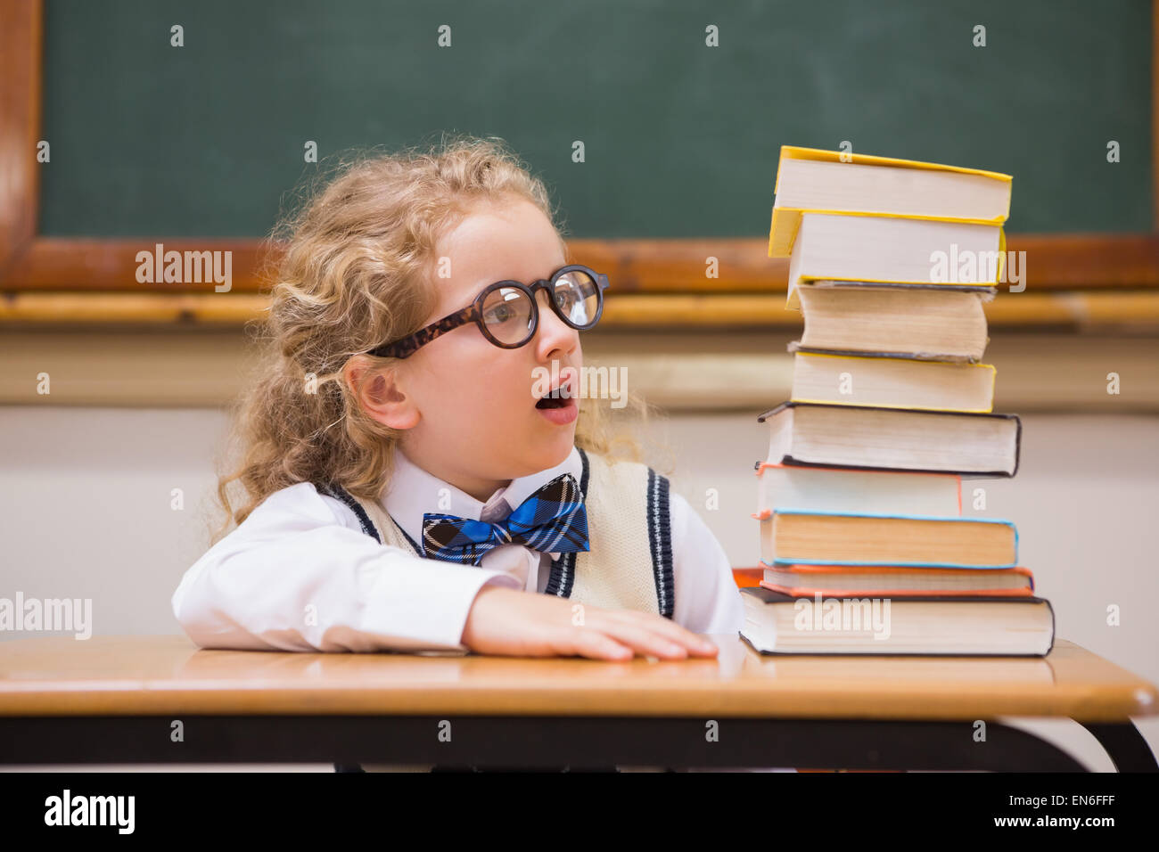 Surprise pupil looking at books Stock Photo - Alamy