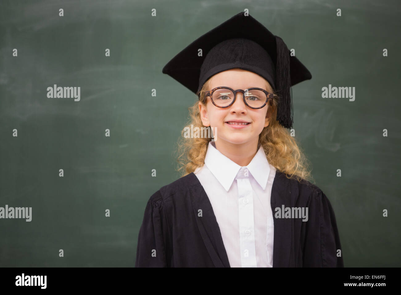 Cute pupil in graduation robe Stock Photo - Alamy