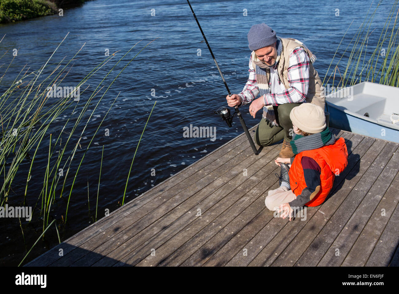 Happy man fishing with his son Stock Photo - Alamy