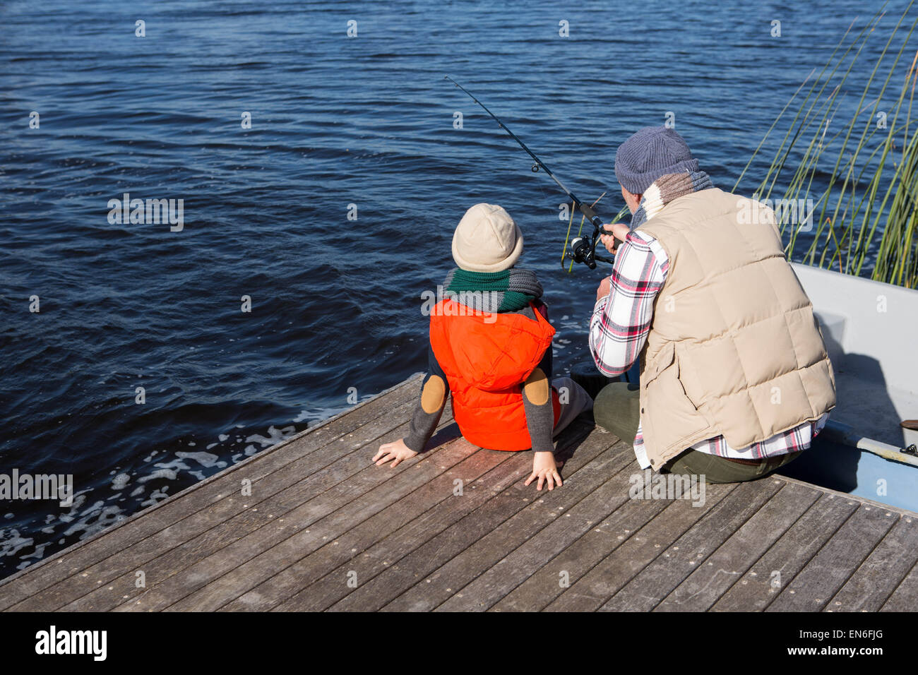 Happy man fishing with his son Stock Photo - Alamy