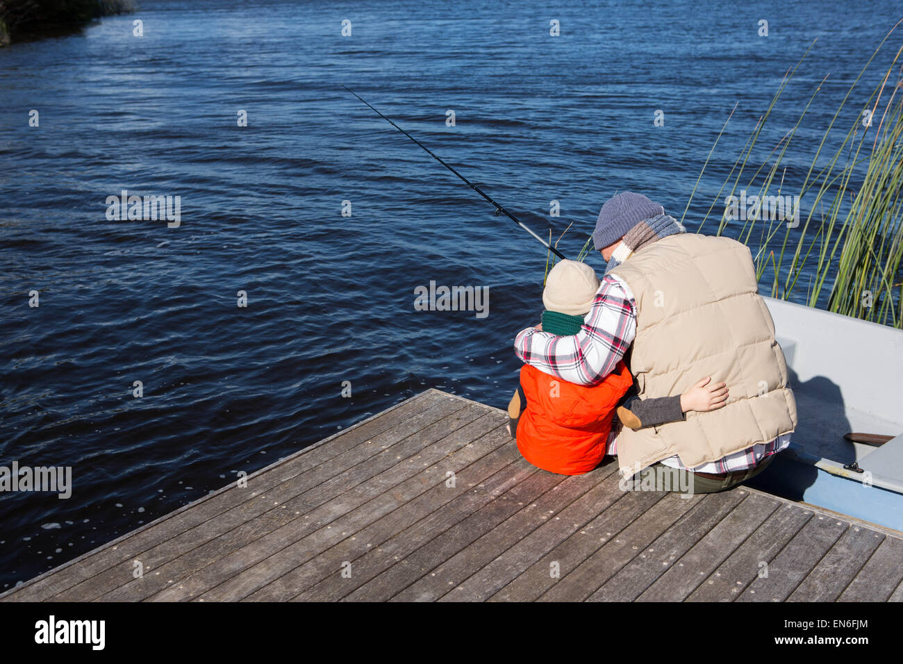 Happy man fishing with his son Stock Photo - Alamy