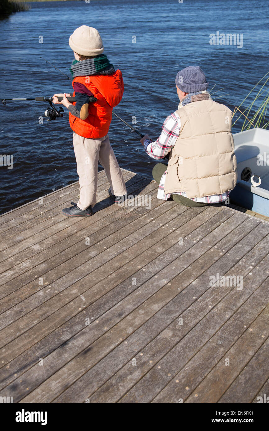 Happy man fishing with his son Stock Photo - Alamy
