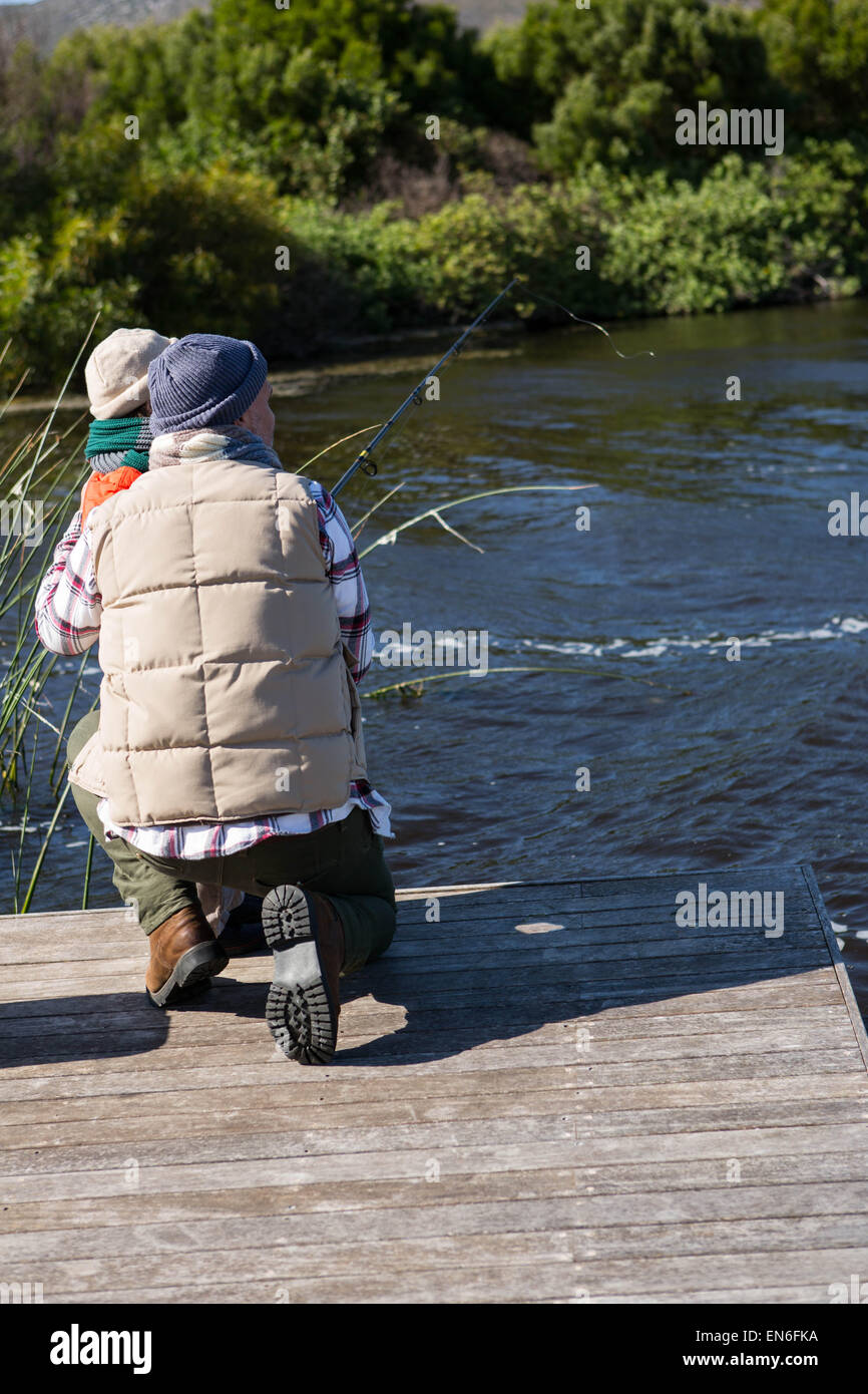 Happy man fishing with his son Stock Photo - Alamy