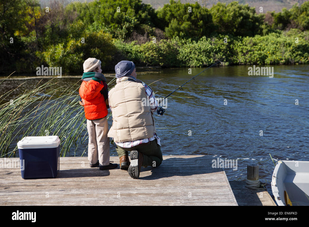 Happy man fishing with his son Stock Photo - Alamy