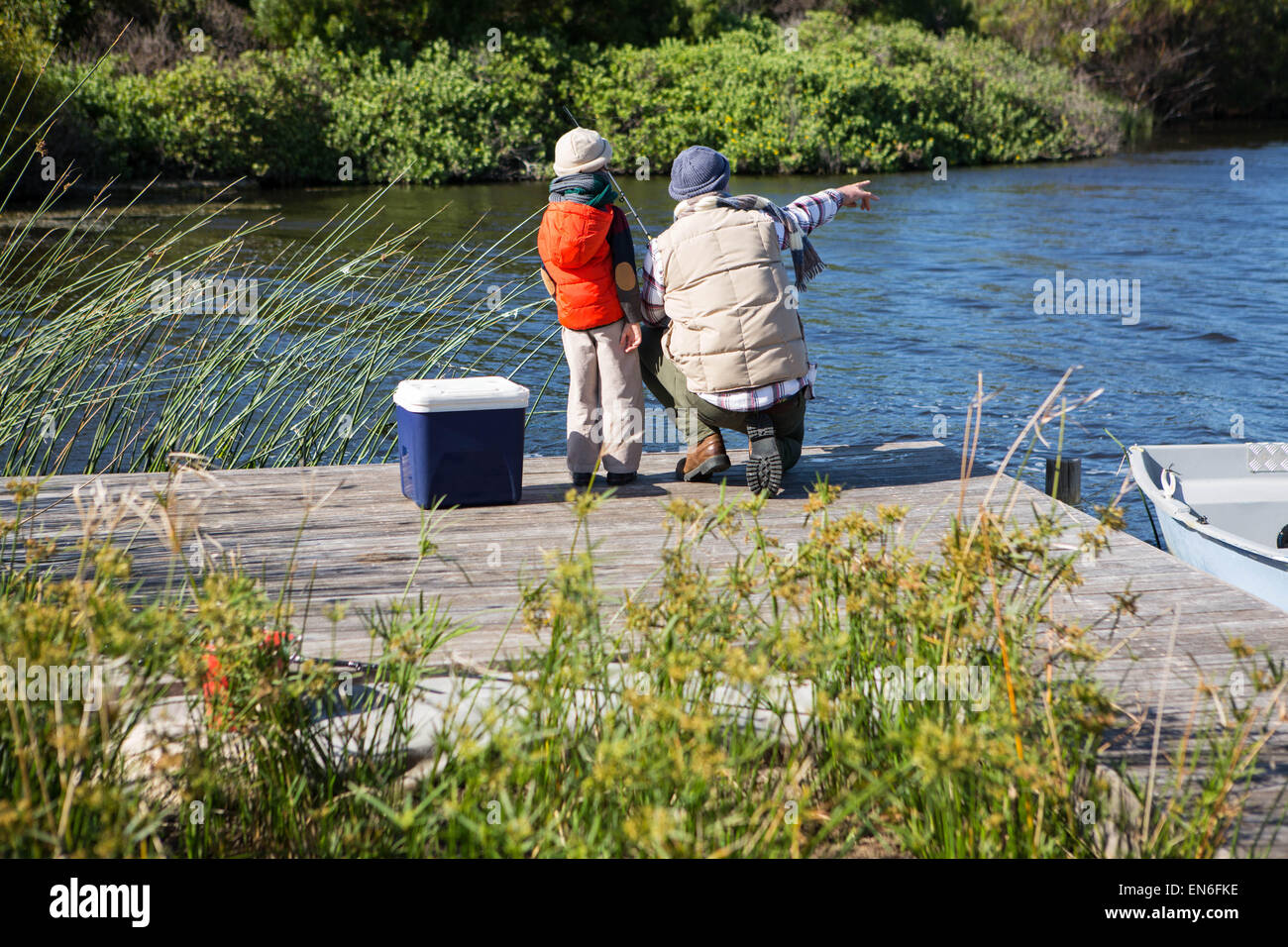 Happy man fishing with his son Stock Photo - Alamy