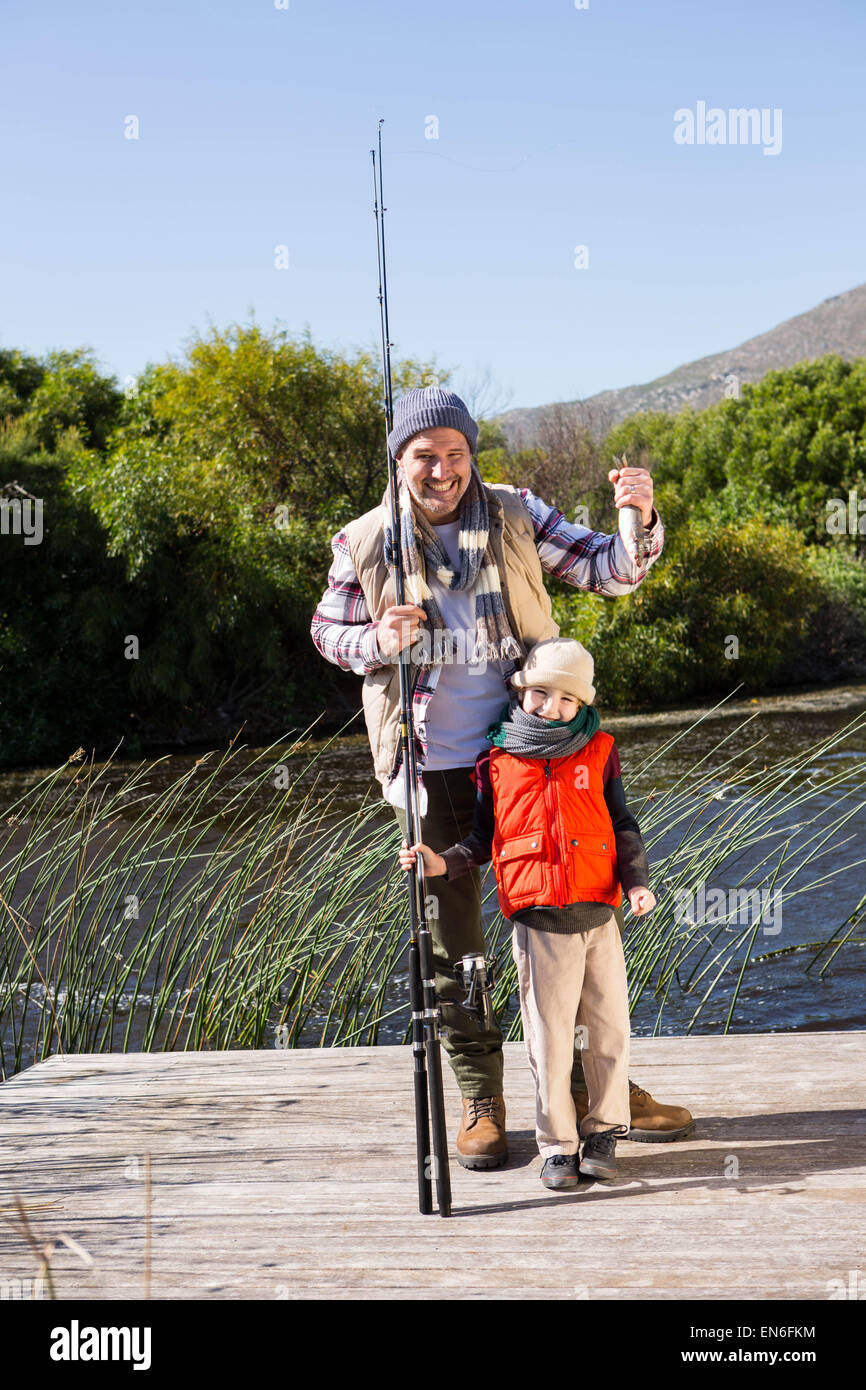 Happy man fishing with his son Stock Photo - Alamy