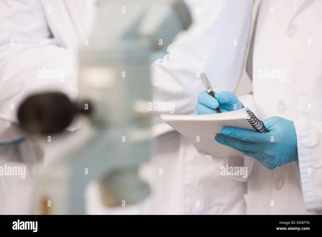 Scientists taking notes Stock Photo - Alamy