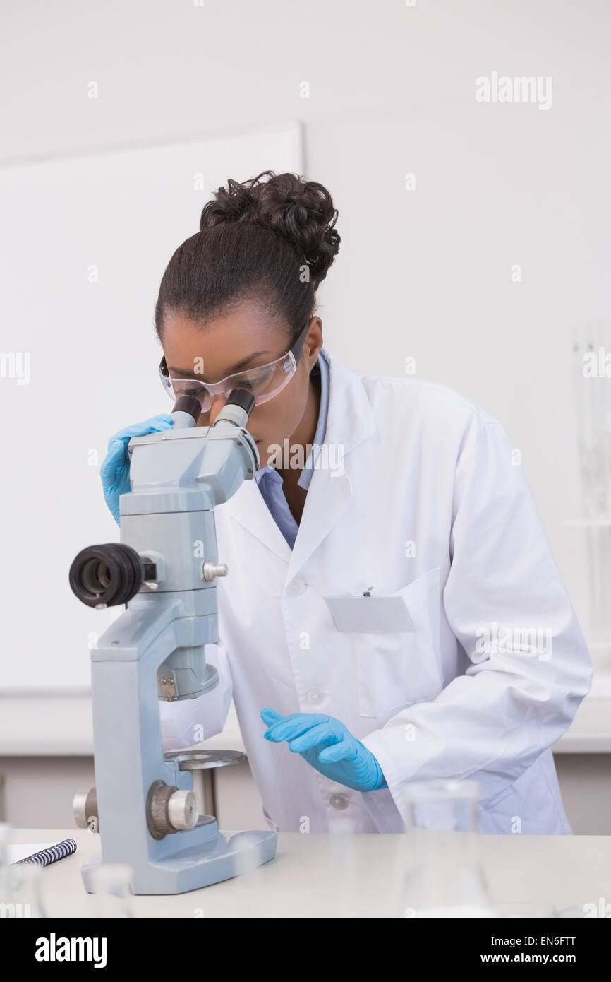 Scientist looking through a microscope Stock Photo - Alamy