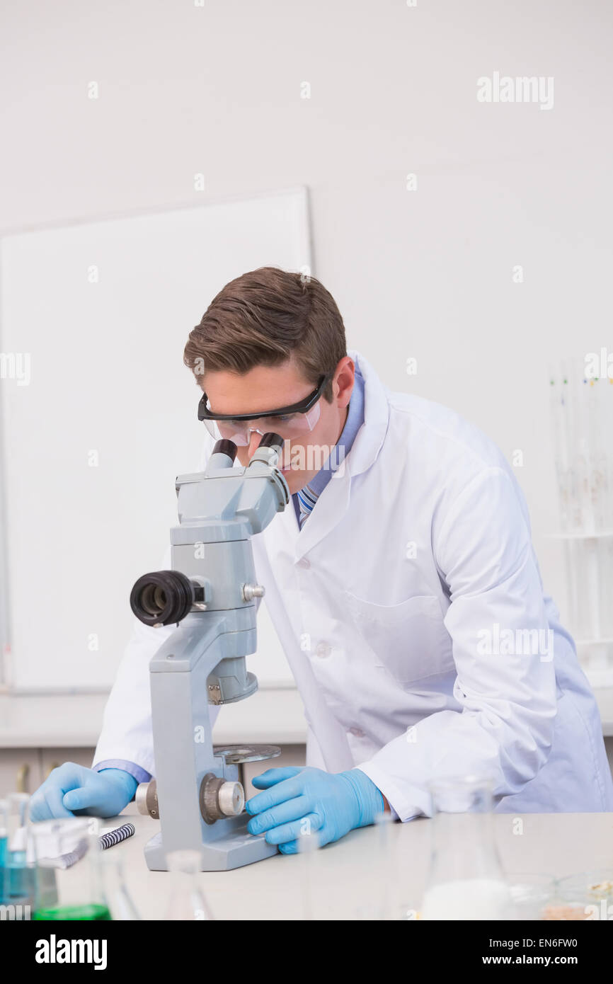 Scientist looking through a microscope Stock Photo - Alamy