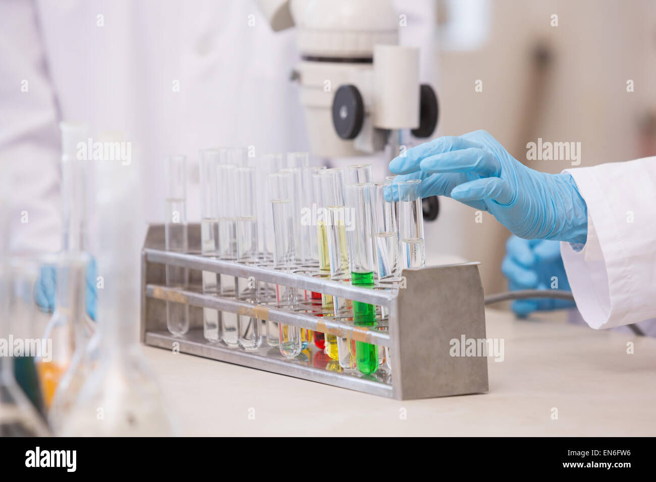 Scientists examining colorful test tubes Stock Photo - Alamy Scientists examining colorful test tubes Stock Photo - Alamy