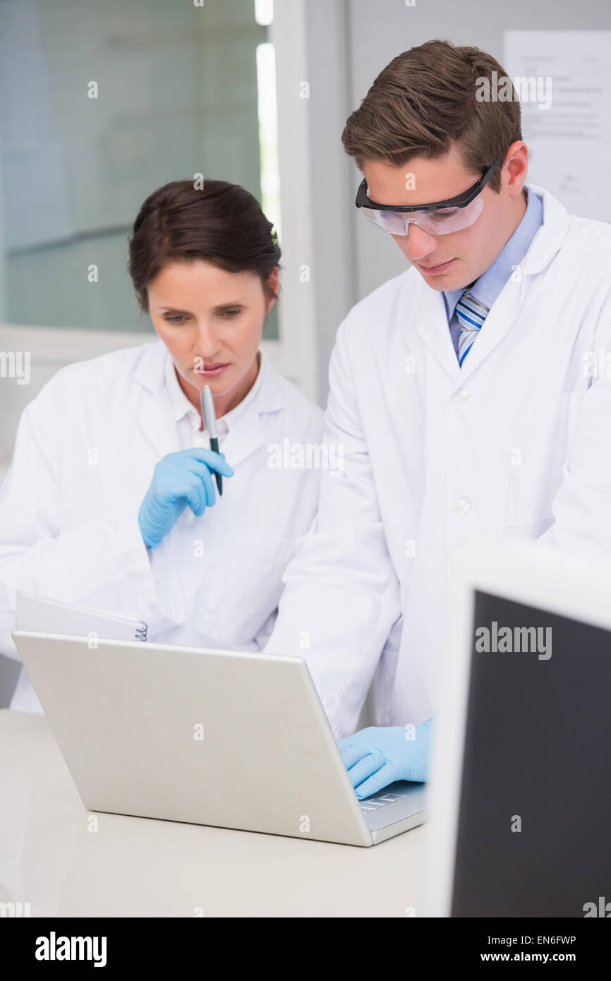 Scientist in protective gloves typing hi-res stock photography and ...