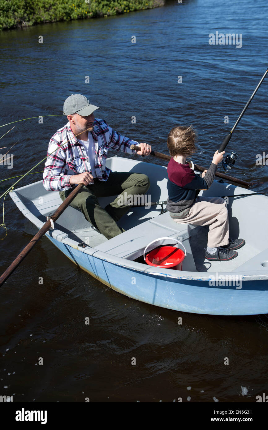 Happy man fishing with his son Stock Photo - Alamy