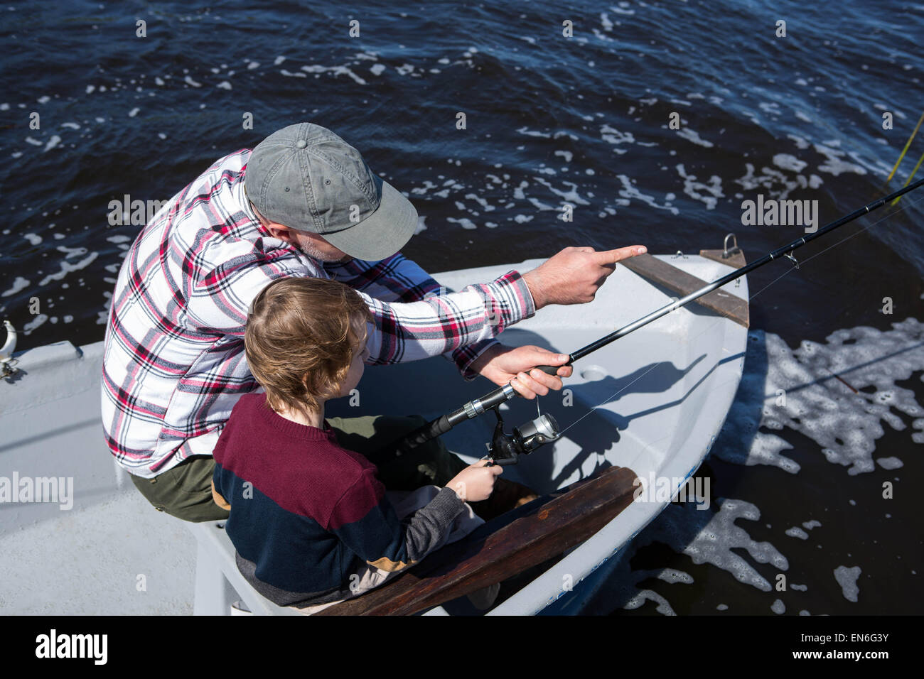 Happy man fishing with his son Stock Photo - Alamy