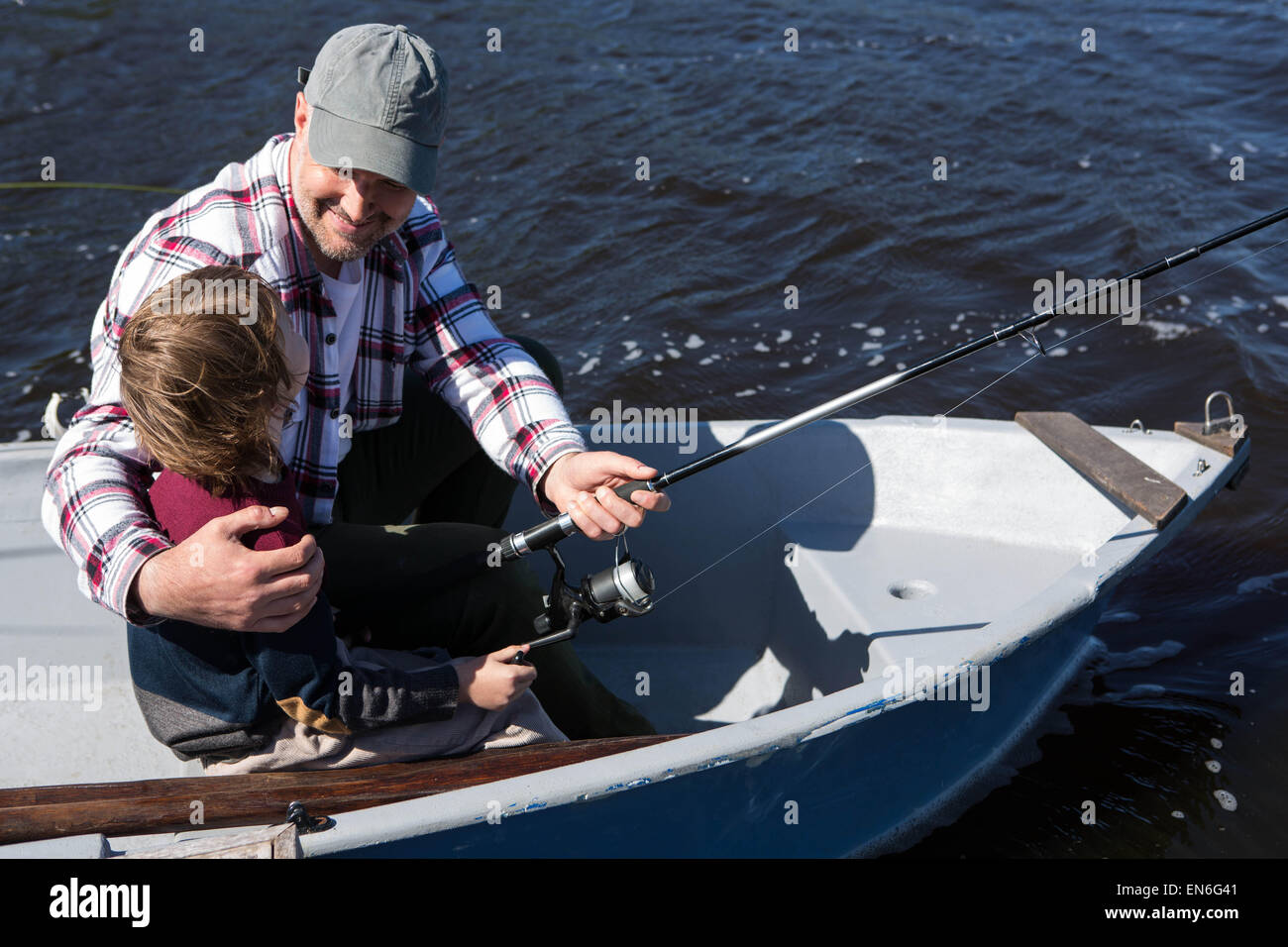 Happy man fishing with his son Stock Photo - Alamy