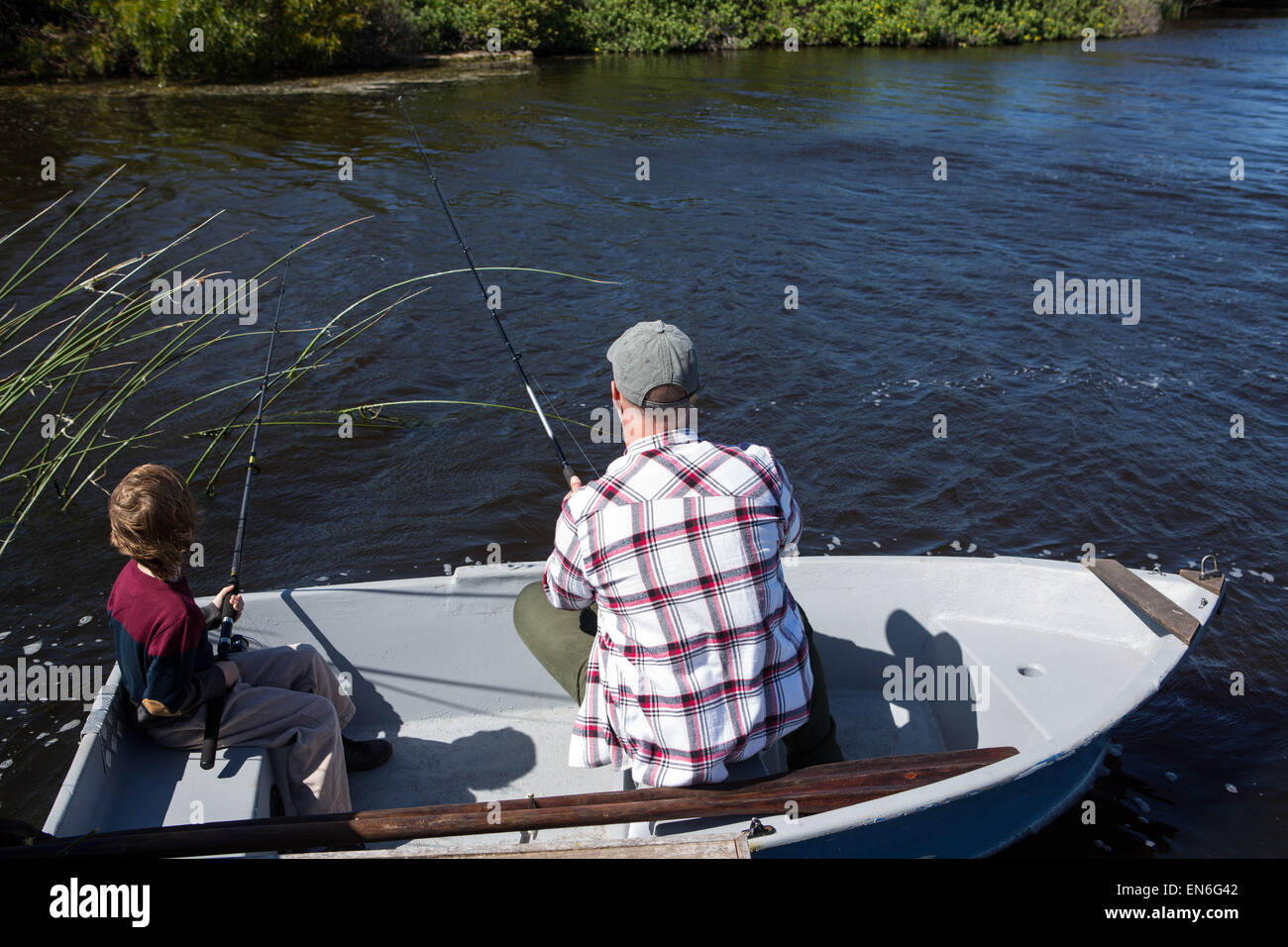 Happy man fishing with his son Stock Photo - Alamy