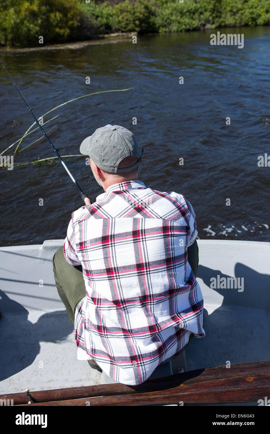 Happy man fishing Stock Photo - Alamy