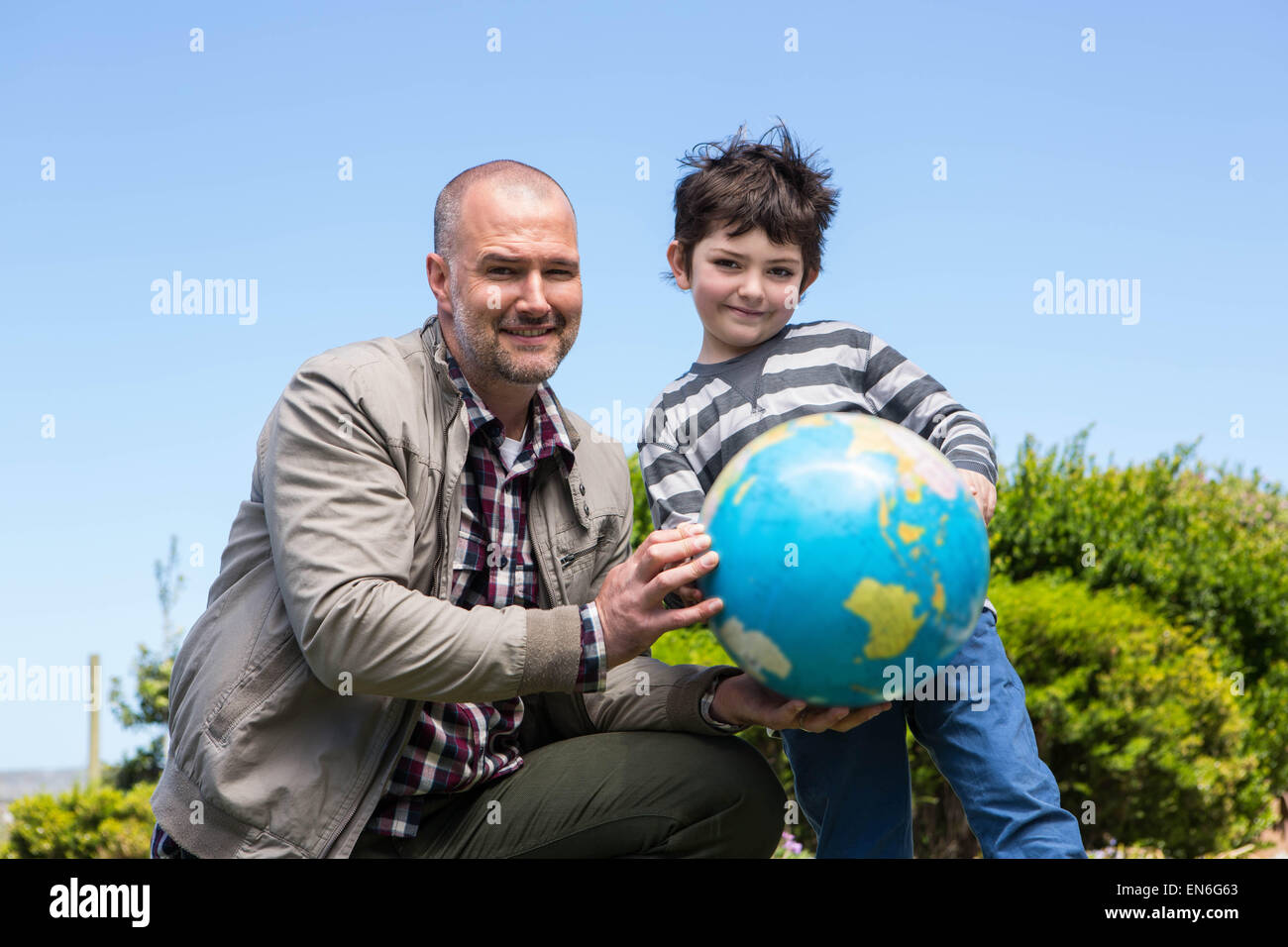 Father and son looking at camera Stock Photo - Alamy
