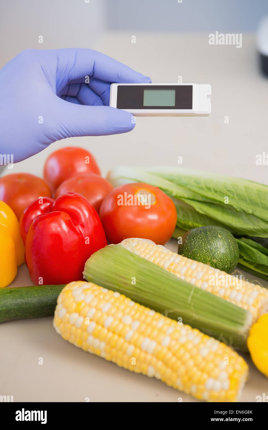 Scientist using device on vegetables Stock Photo - Alamy