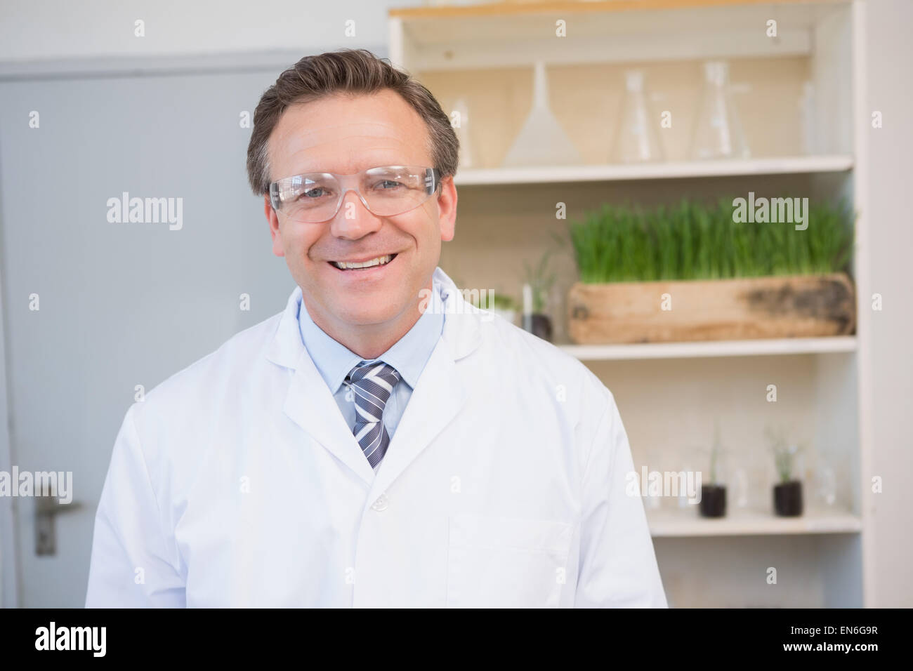Happy scientist smiling at camera Stock Photo - Alamy