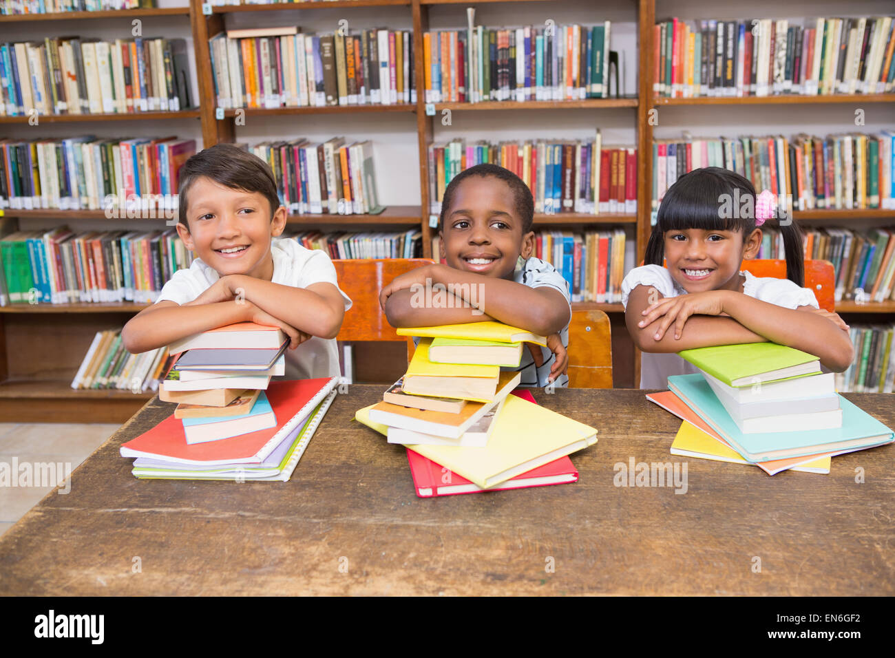 Cute pupil smiling camera desk hi-res stock photography and images - Alamy