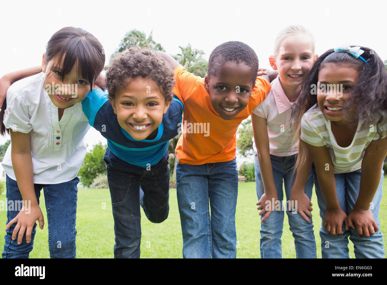 Happy friends playing in the park Stock Photo - Alamy