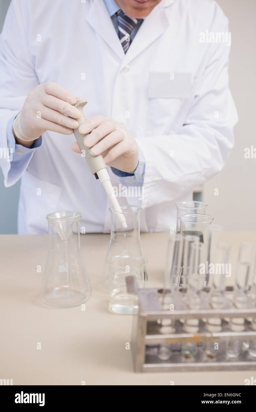 Scientist doing experimentations in erlenmeyer Stock Photo - Alamy