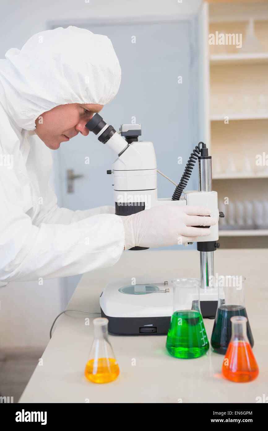 Scientist examining sample with microscope Stock Photo - Alamy