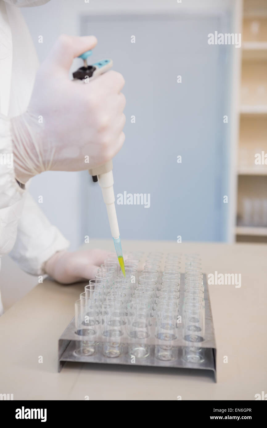 Scientist injecting tubes Stock Photo - Alamy