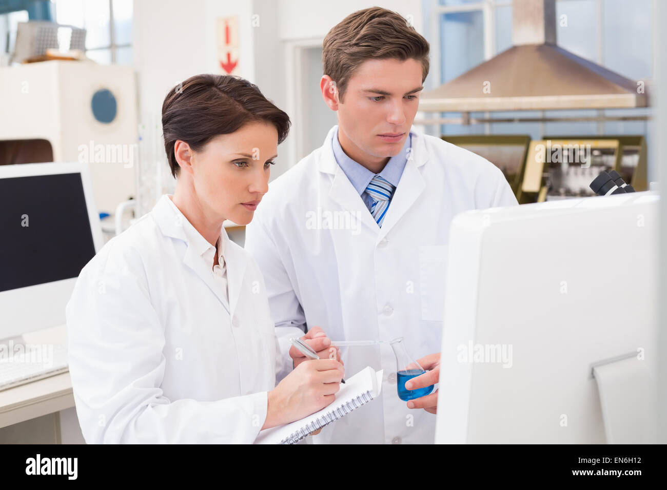 Scientists looking attentively at computer Stock Photo - Alamy