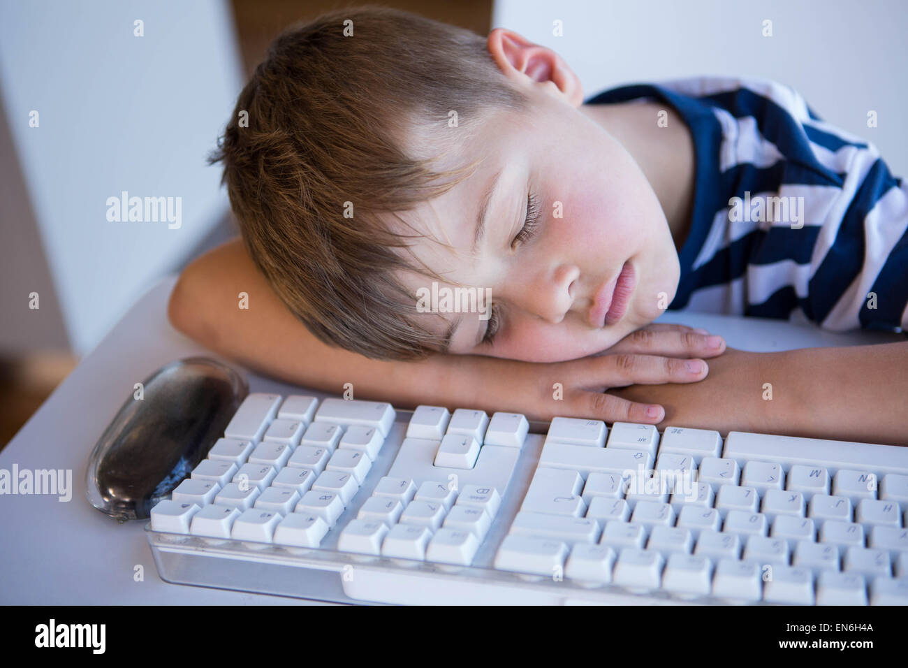 Little boy slipping on table Stock Photo - Alamy