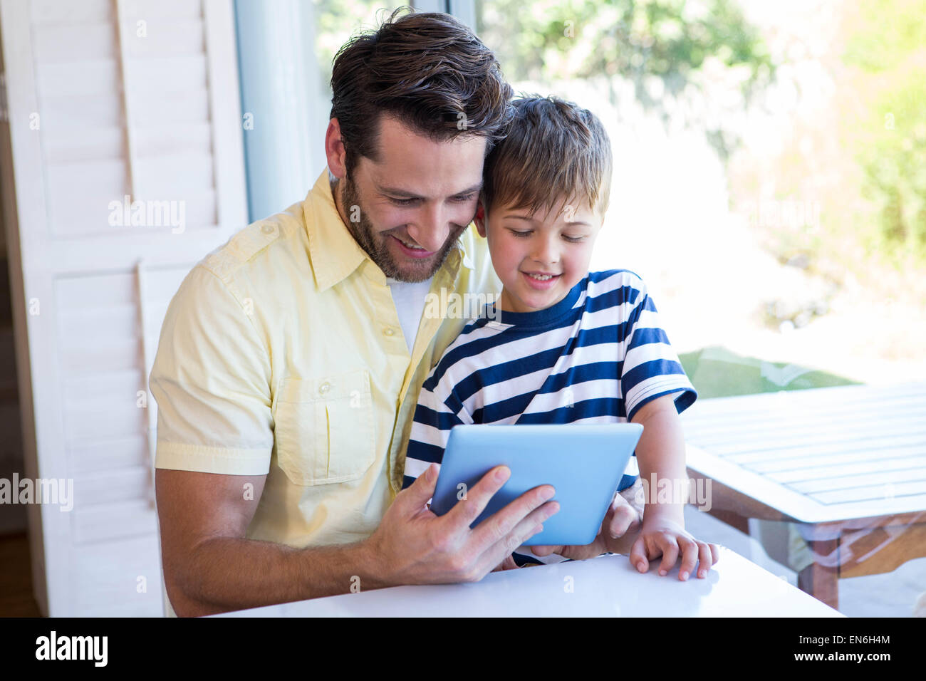 Father son using touchscreen tablet hi-res stock photography and images ...