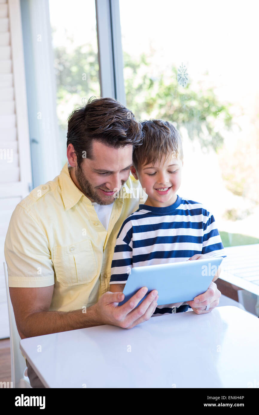 Father son using touchscreen tablet hi-res stock photography and images ...