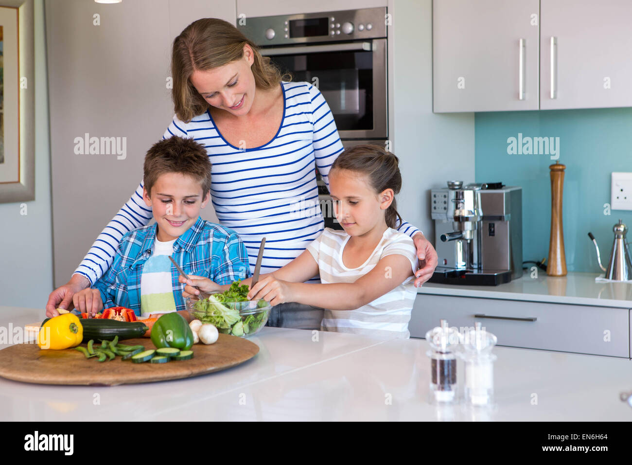 Happy family preparing lunch together Stock Photo - Alamy