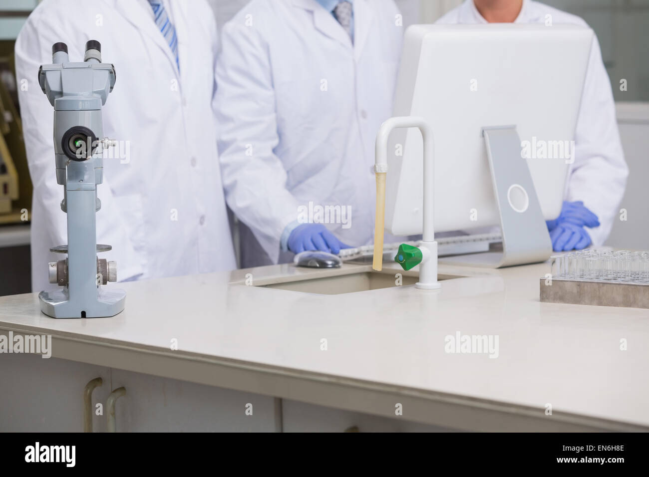 Scientists working on computer together Stock Photo - Alamy
