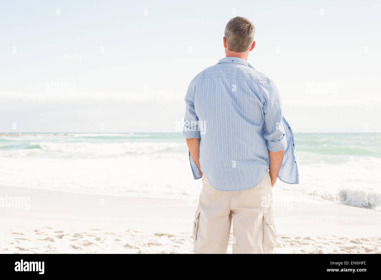 Man looking out to sea Stock Photo - Alamy