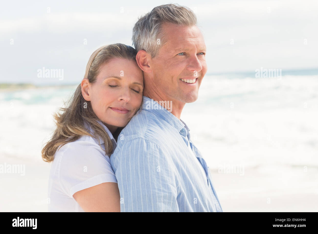 Happy couple hugging standing hi-res stock photography and images - Alamy