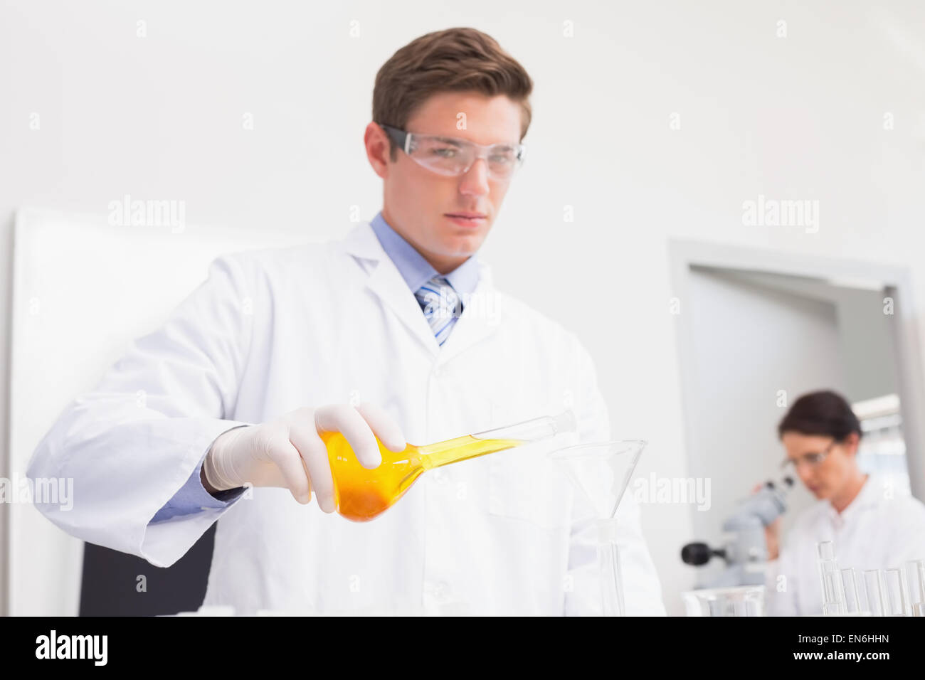 Scientists working attentively with test tube and microscope Stock ... Scientists working attentively with test tube and microscope Stock ...