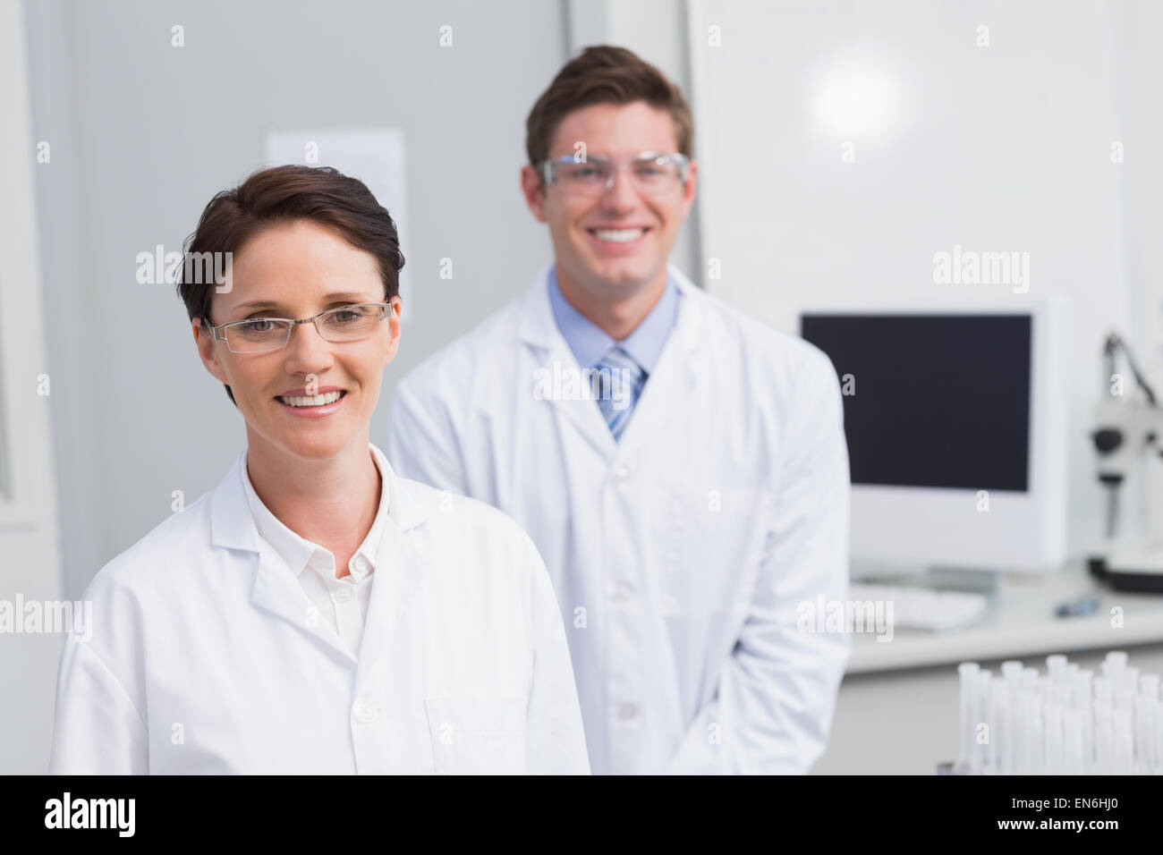 Scientists smiling and looking at camera Stock Photo - Alamy