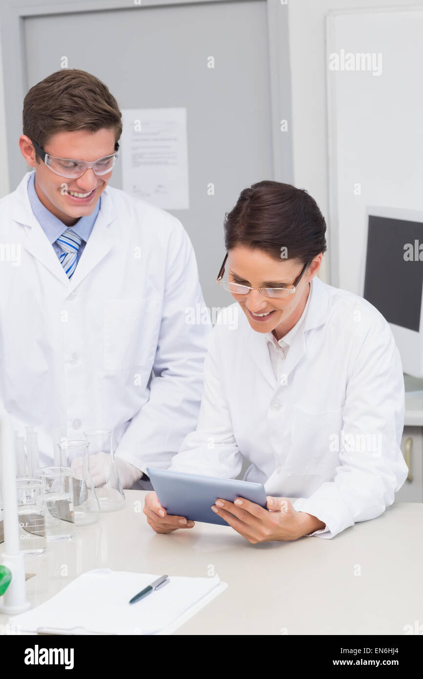 Smiling scientists using tablet Stock Photo - Alamy