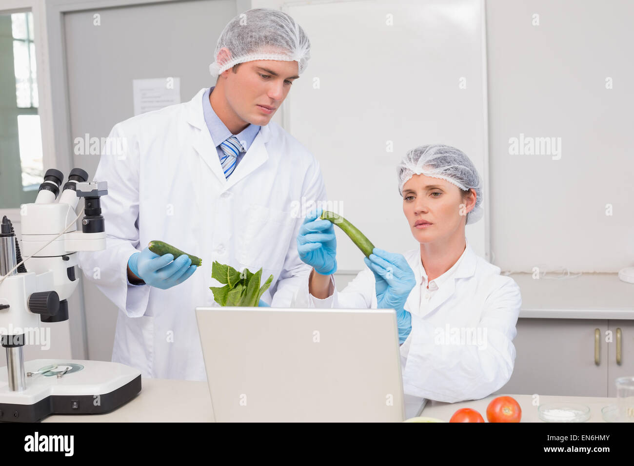 Scientists examining green pepper Stock Photo - Alamy