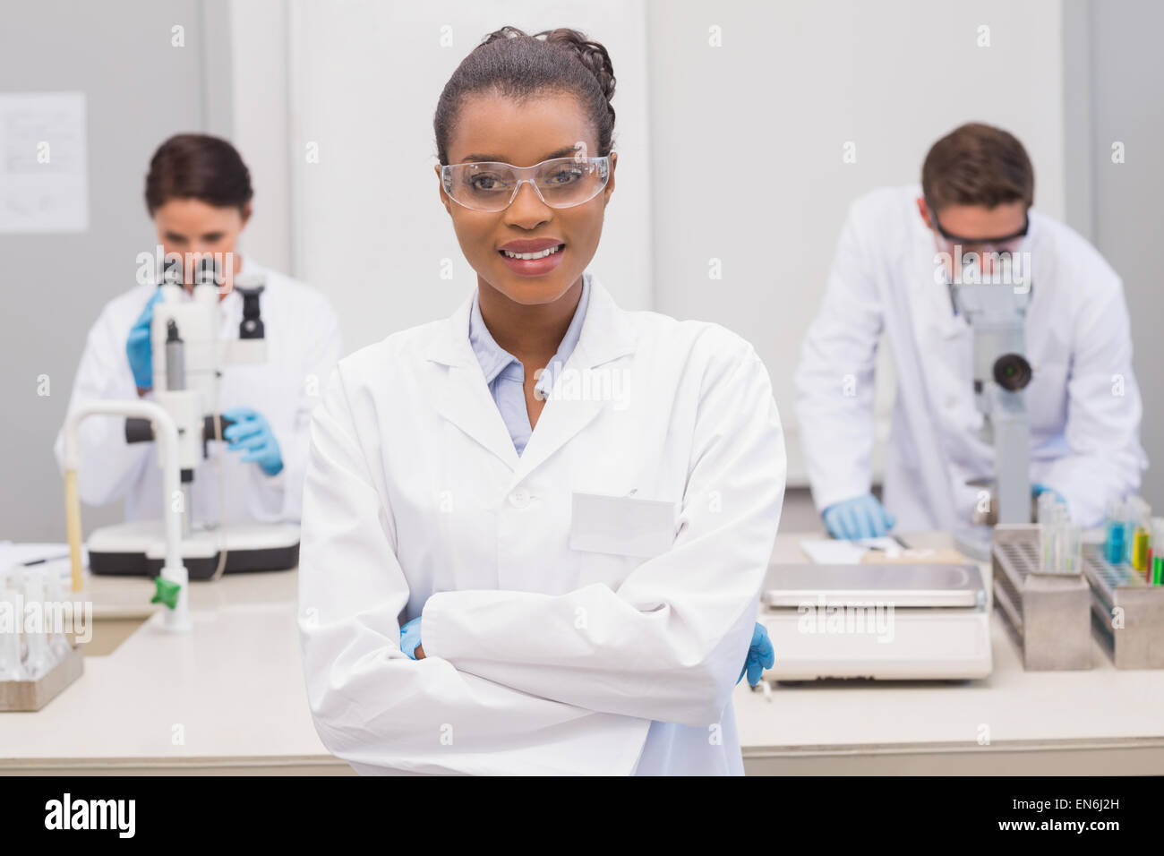 Happy scientist smiling at camera with protective glasses Stock Photo ...