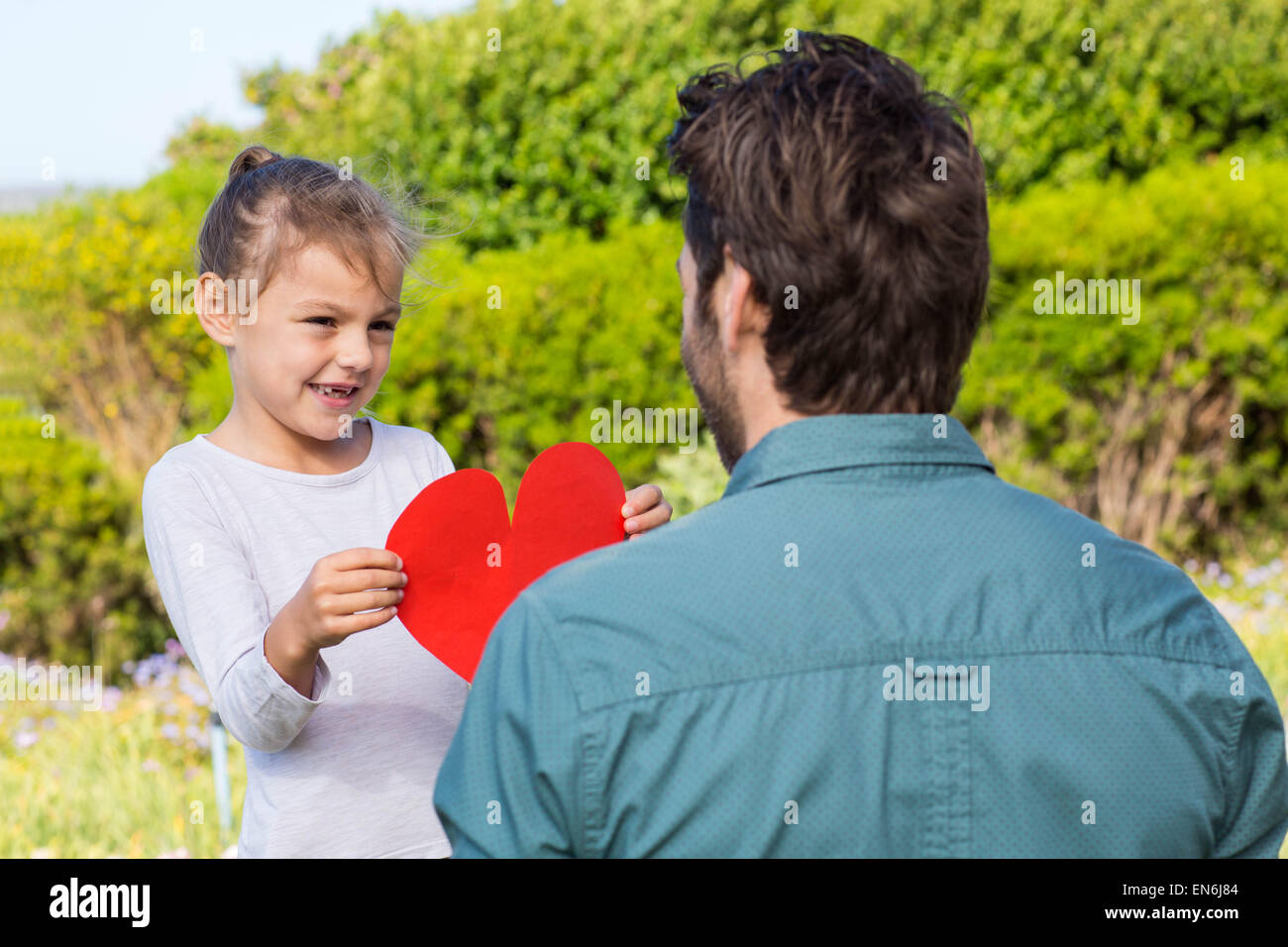 Daughter giving dad a heart card Stock Photo - Alamy