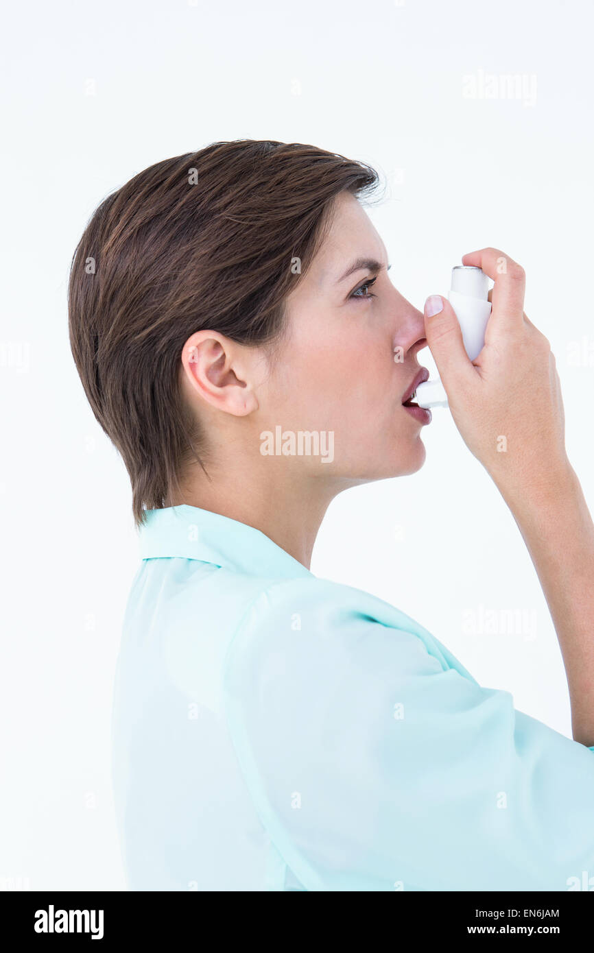 Pretty woman using her inhaler Stock Photo - Alamy