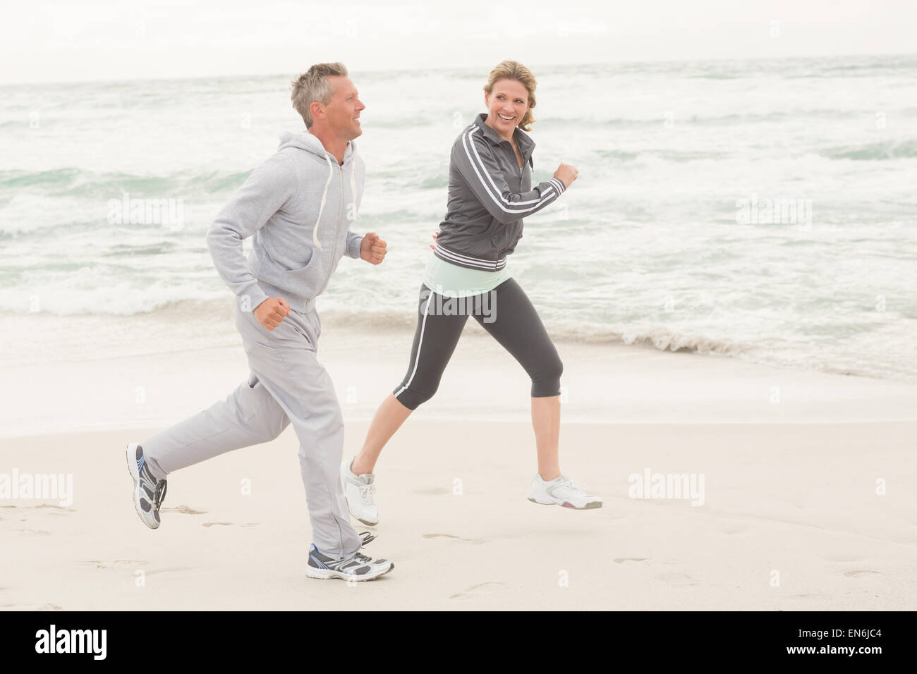 Fit couple jogging together Stock Photo - Alamy