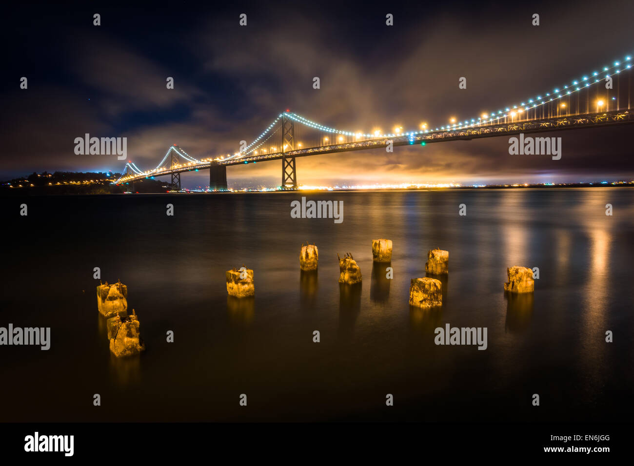 Pier pilings and the San Francisco - Oakland Bay Bridge at night, in ...