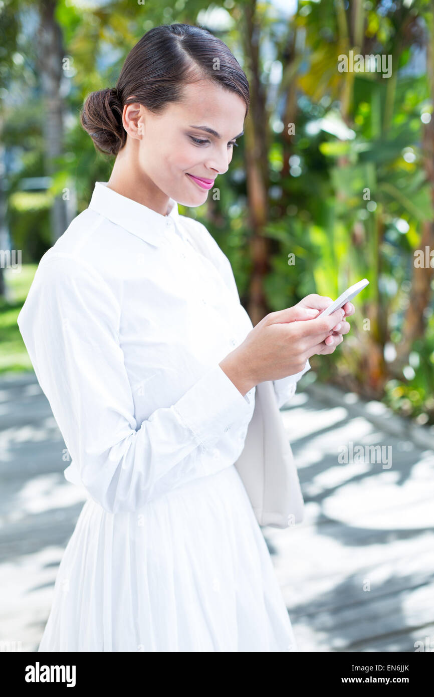 Woman using smartphone white shirt hi-res stock photography and images ...